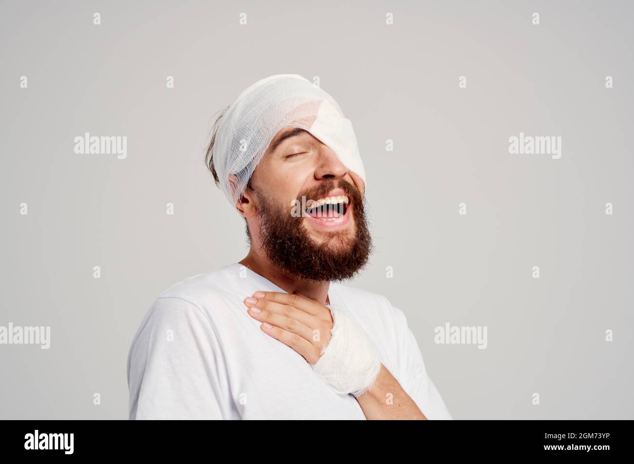 bearded man head injury in white t-shirt headache hospital medicine ...