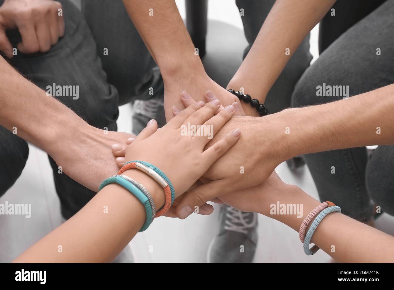 People putting hands together as symbol of unity Stock Photo - Alamy
