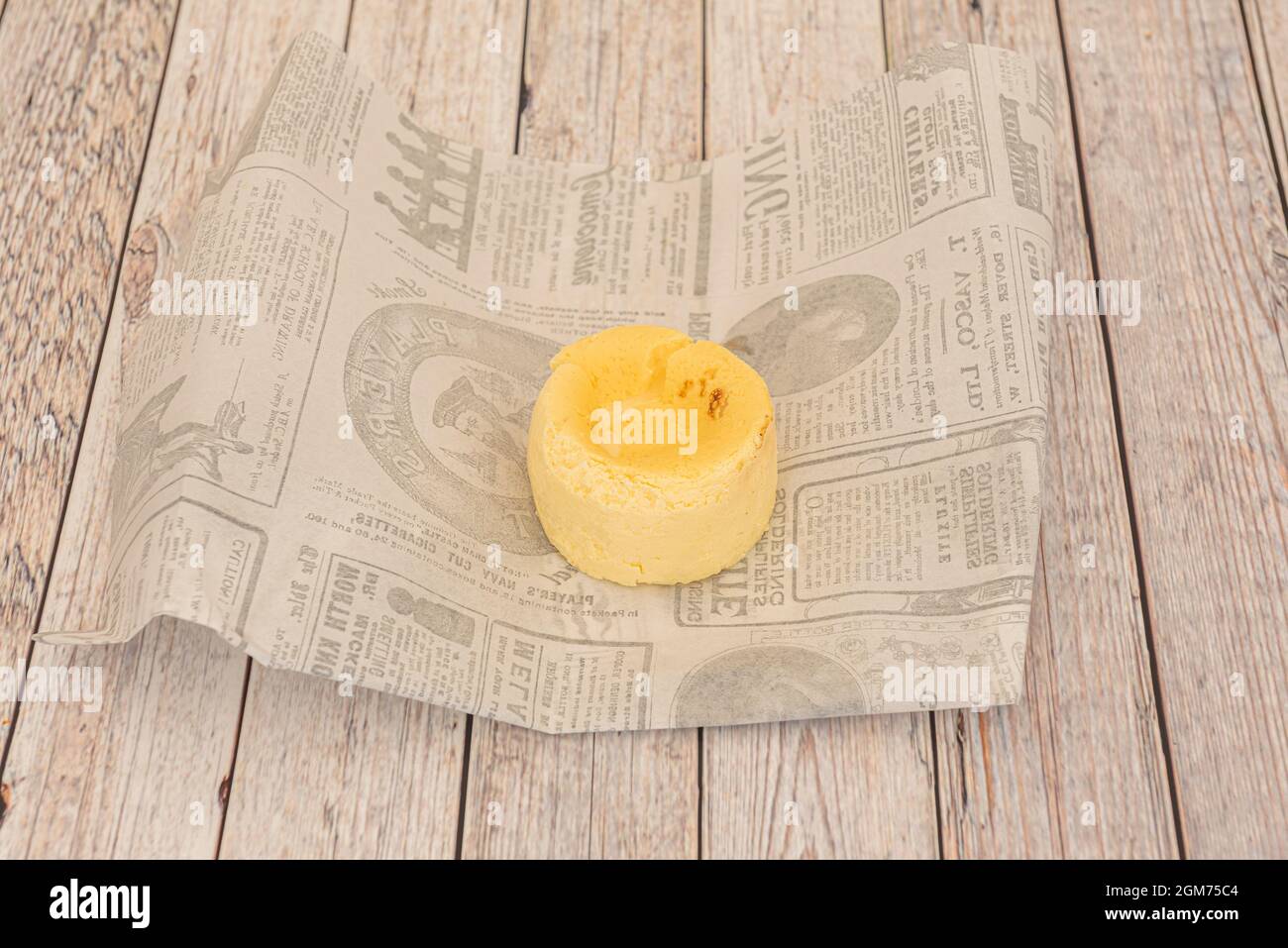 Delicious individual round cheesecake on a sheet of newspaper Stock ...