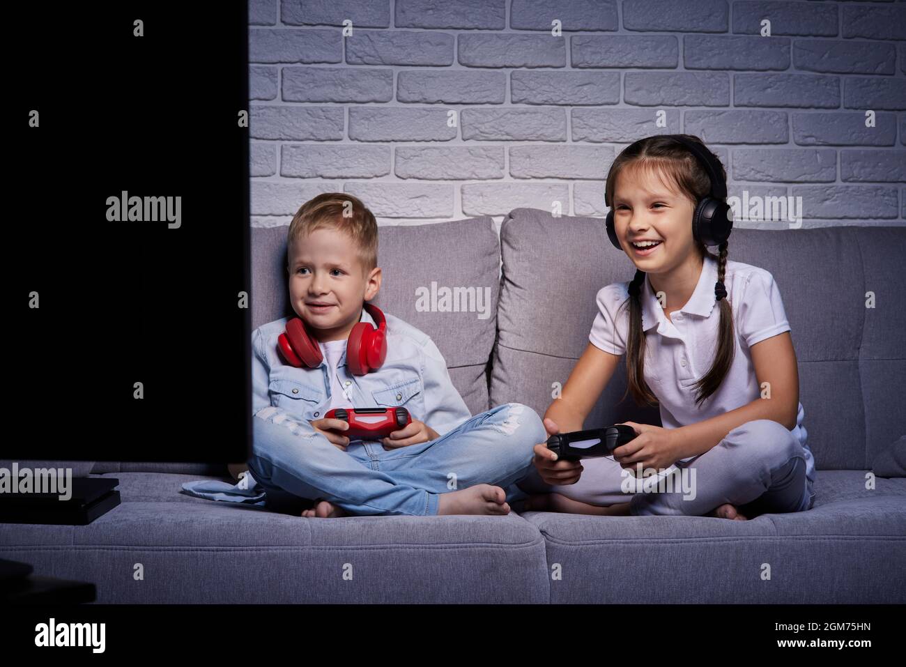 children playing video game with game console Stock Photo - Alamy