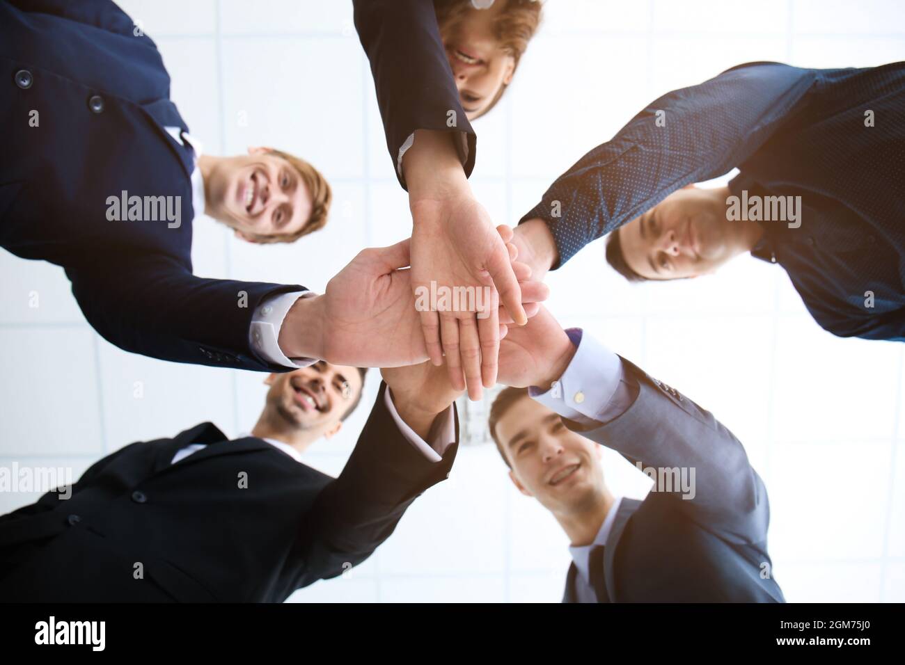 People putting hands together, view from below. Unity concept Stock ...