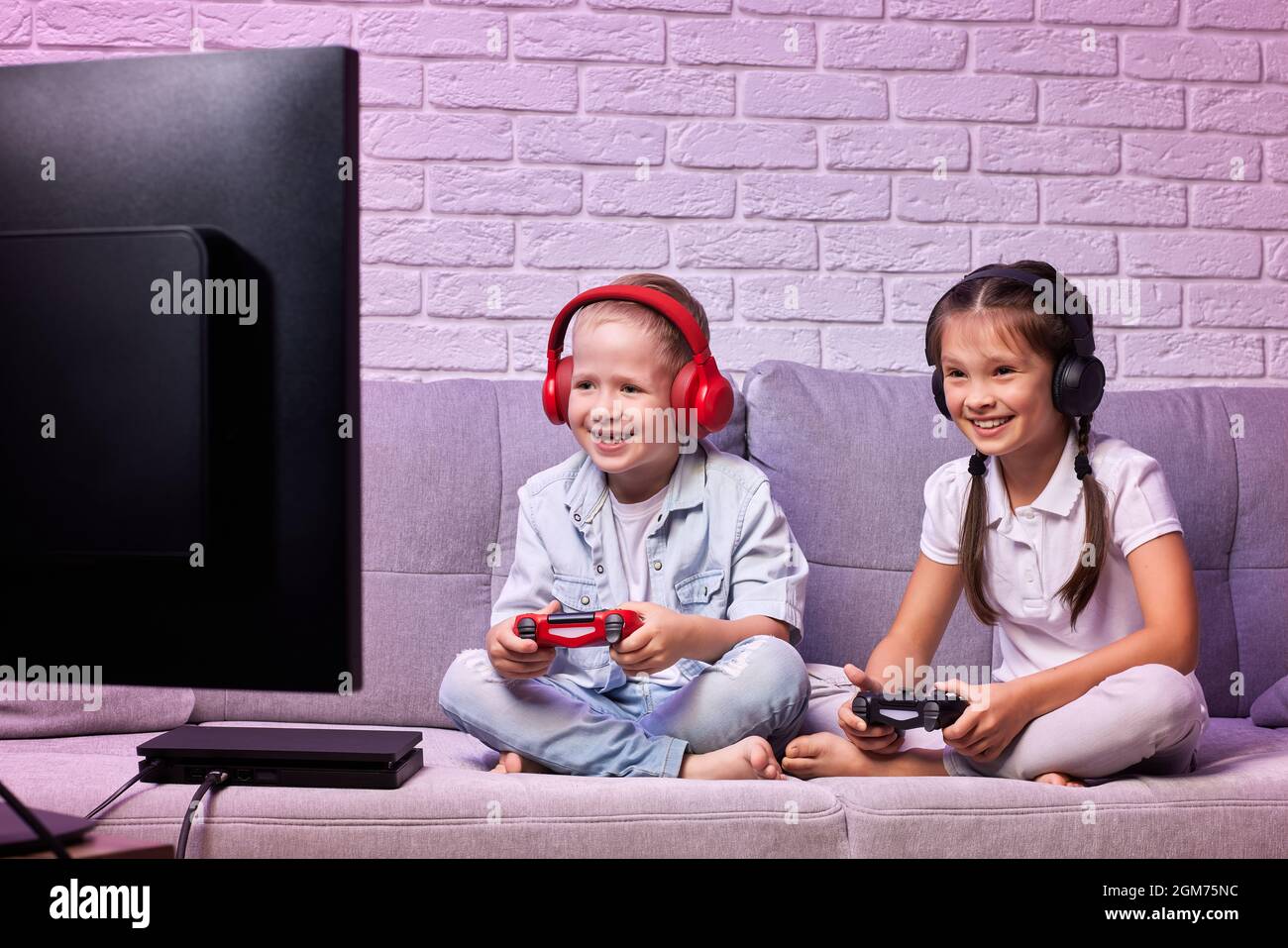 children playing video game with game console Stock Photo - Alamy