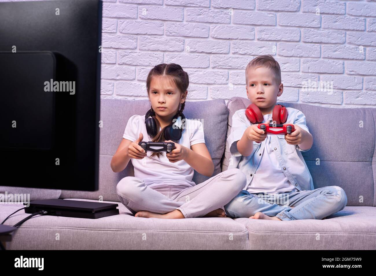 children playing video game with game console Stock Photo - Alamy