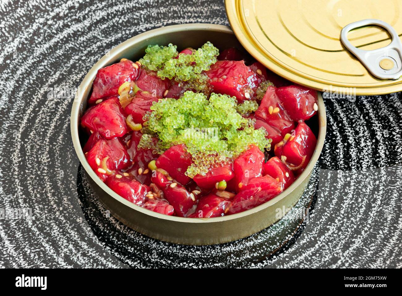 marinated red tuna tartare with sesame seeds, onion and fish roe in a ...