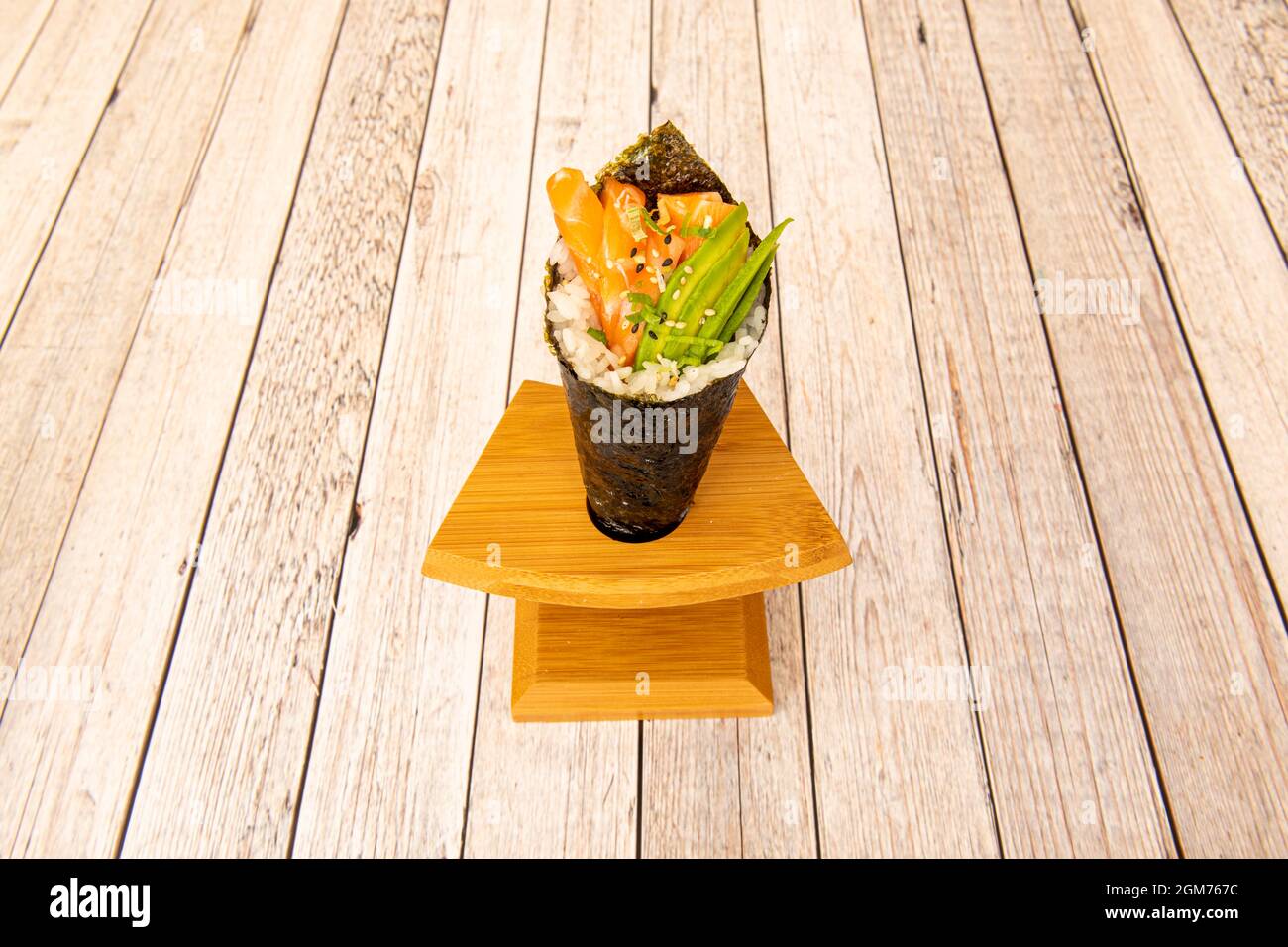 Norwegian salmon temaki sushi with ripe avocado, sesame seeds, nori ...