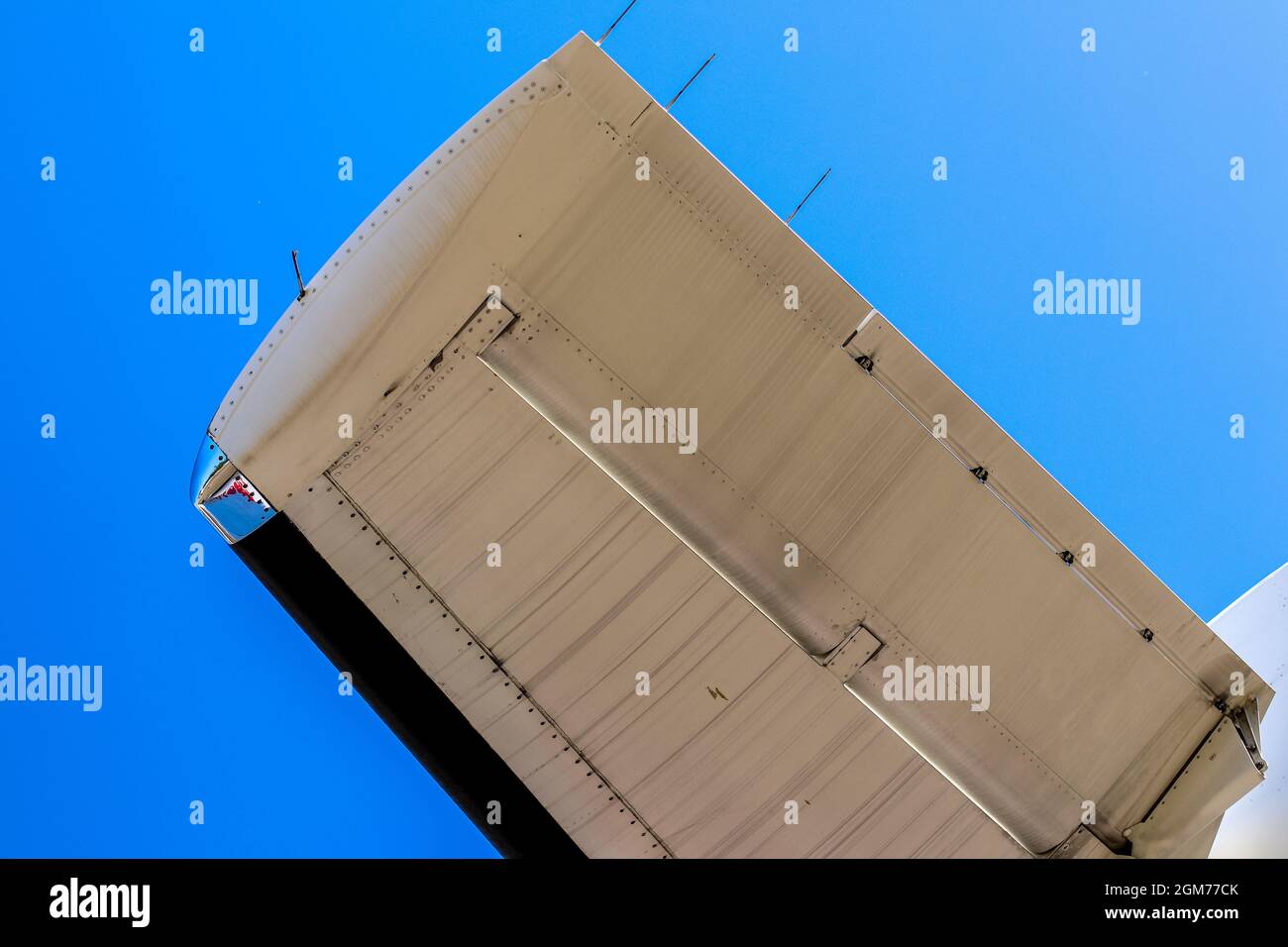 Detail of one of the rear wing of the aircraft with blue sky in ...