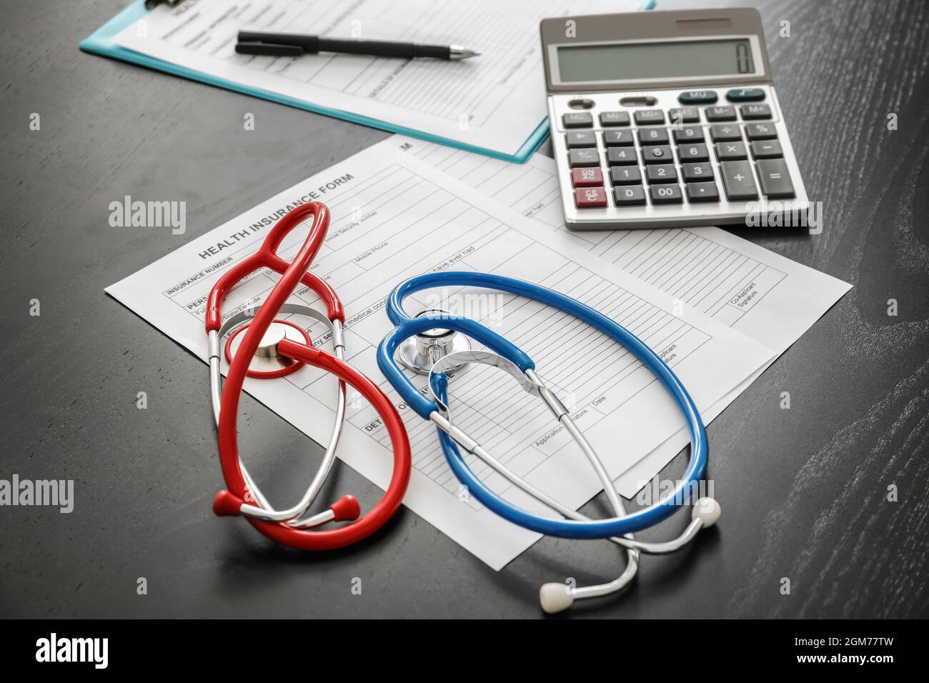 Health insurance form and stethoscopes on table, closeup Stock Photo ...
