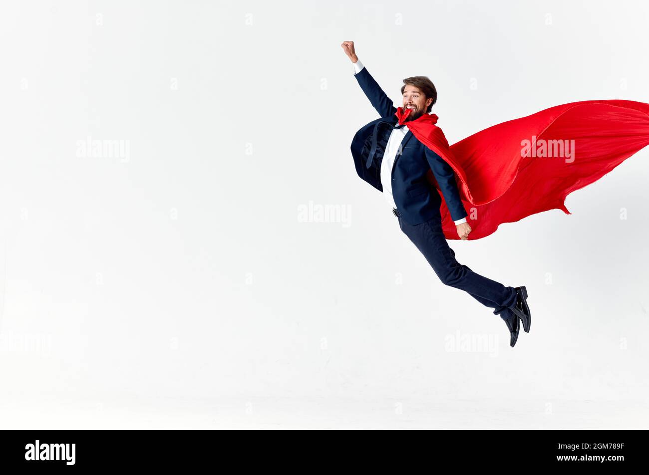 man wearing red cape superman jump Stock Photo - Alamy