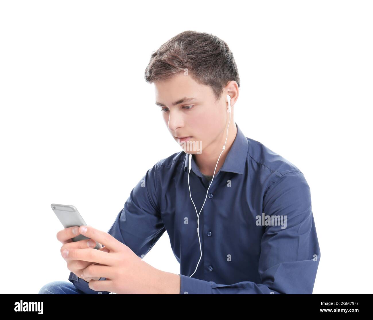 Stylish teenager using mobile phone against white background Stock ...