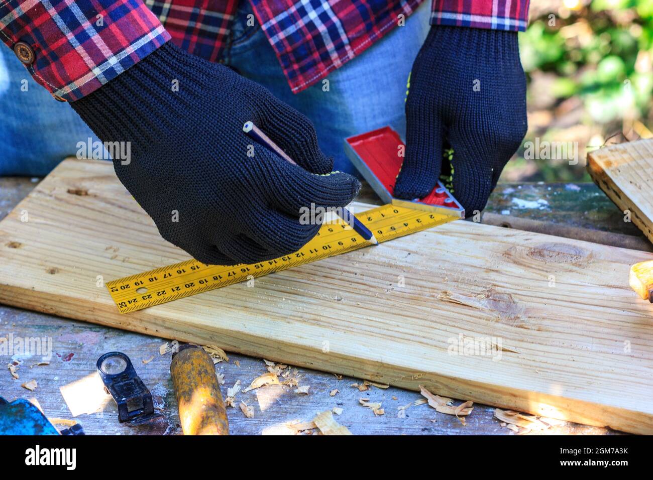 Guy makes a drawing with a construction ruler on wooden boards Stock ...