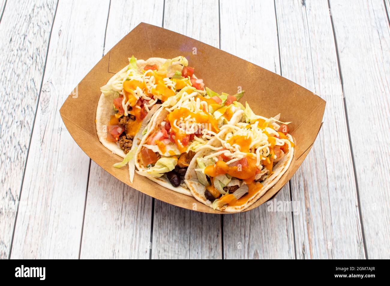 Cardboard tray with trio of tacos with wheat tortillas, with pumpkin ...