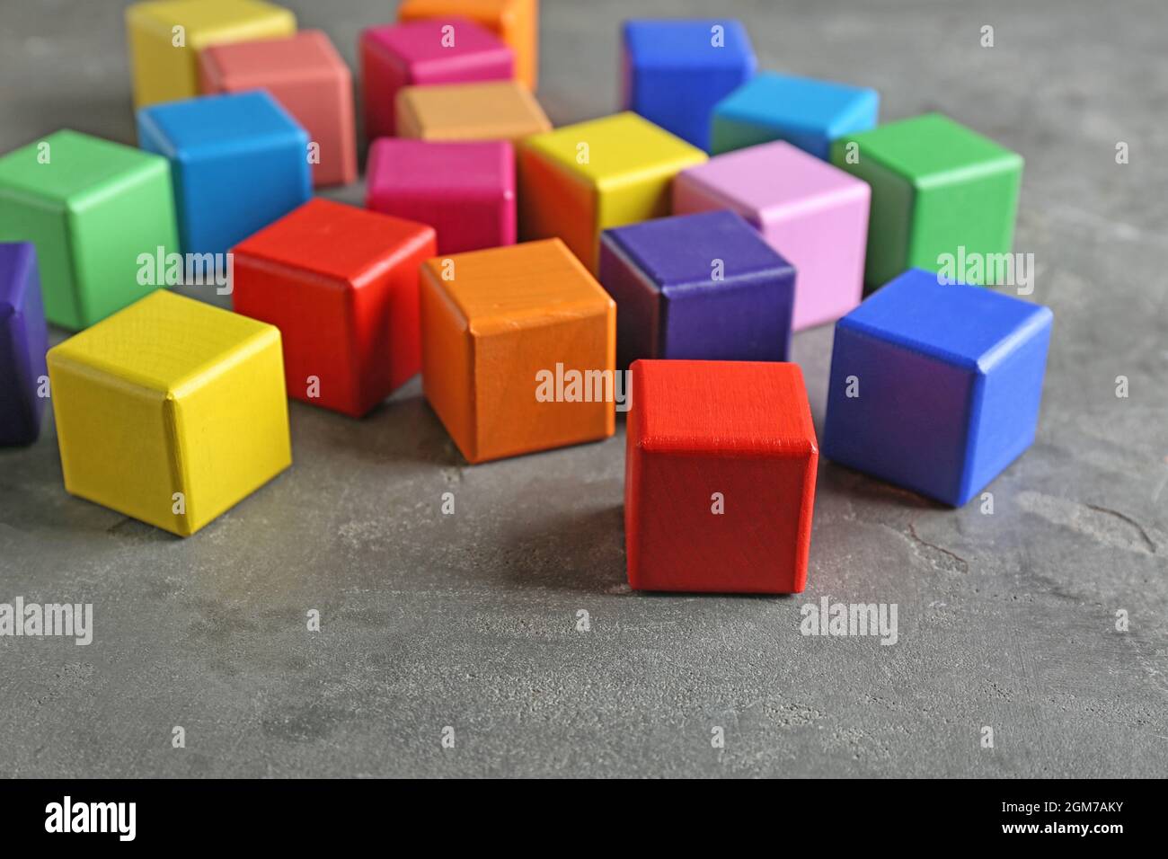 Color cubes on grey background. Unity concept Stock Photo - Alamy