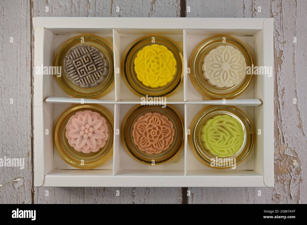 An assortment of colorful mini snow skin mooncakes in a presentation ...