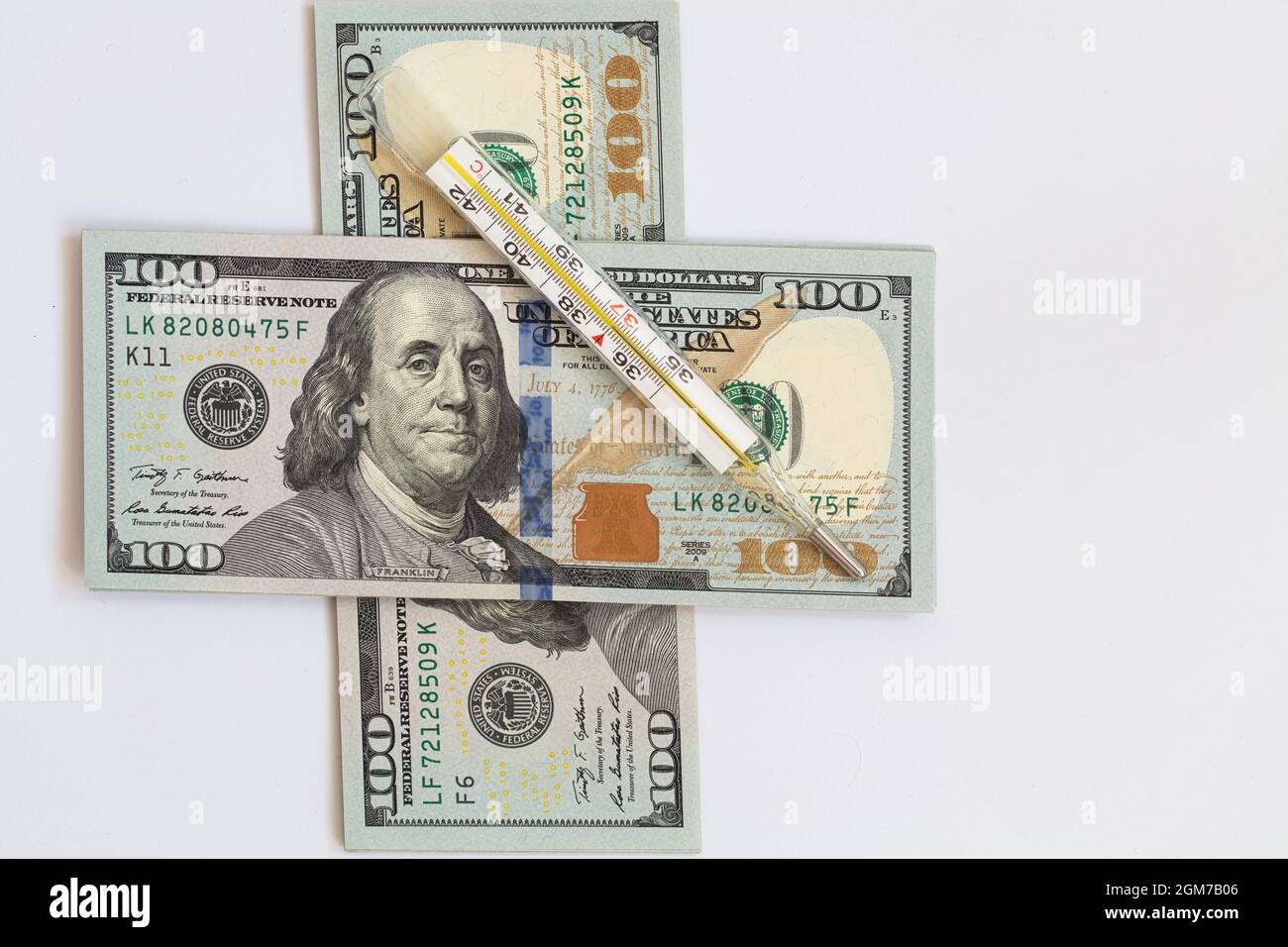 100 dollar bill and thermometer Stock Photo - Alamy