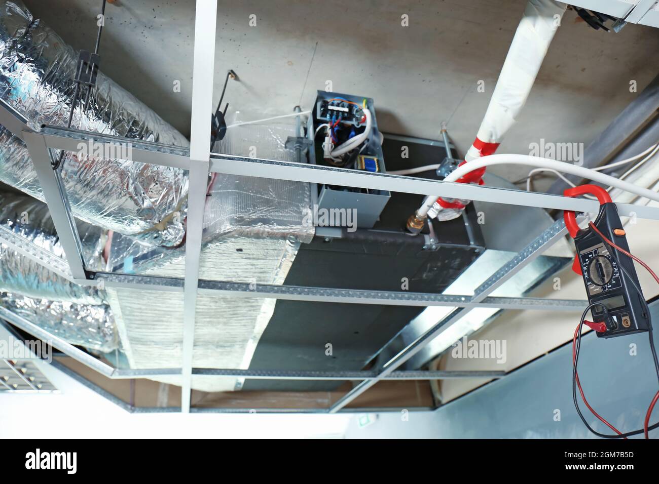 Industrial air conditioner and multimeter hanging on ceiling beam ...