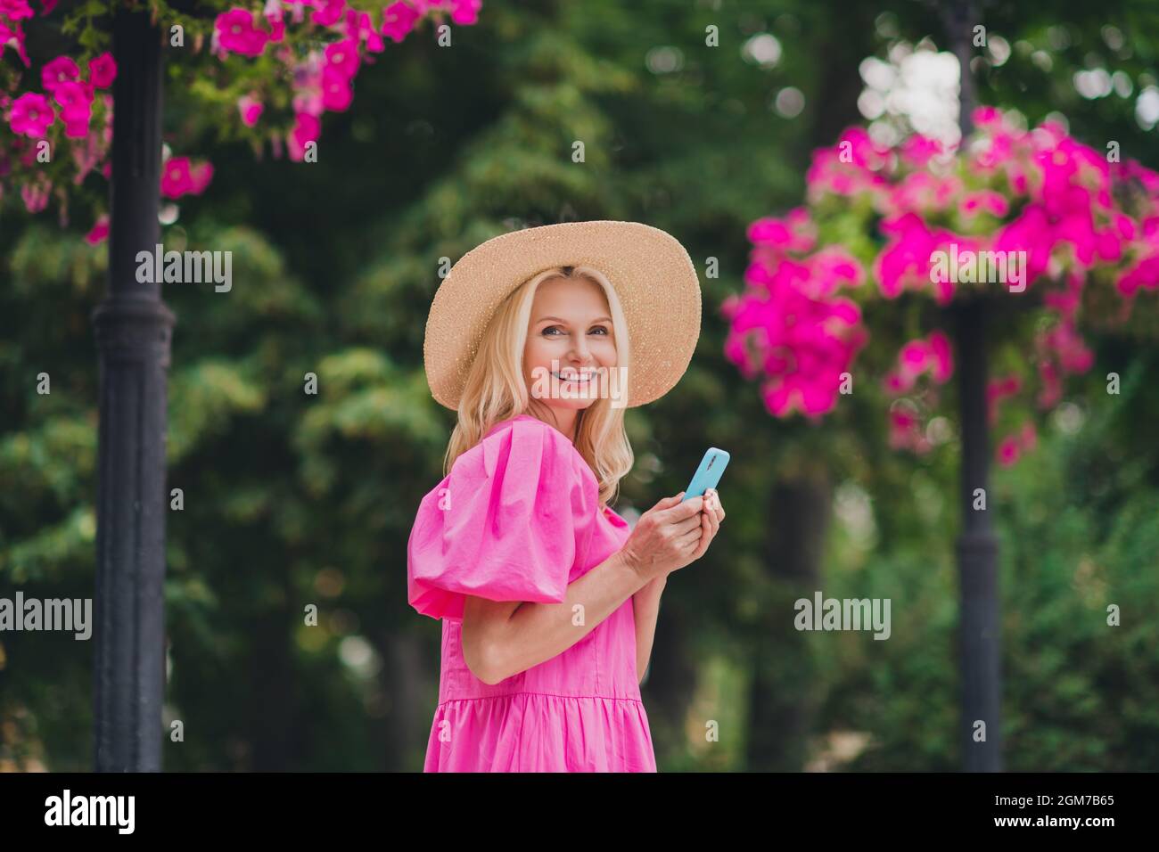 Photo of cute pretty retired lady wear pink outfit headwear smiling ...