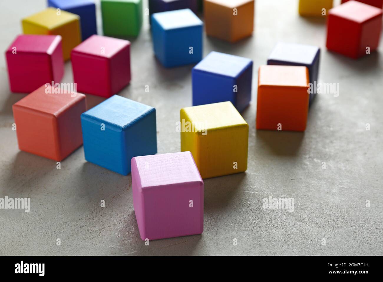 Color cubes on grey background. Unity concept Stock Photo - Alamy