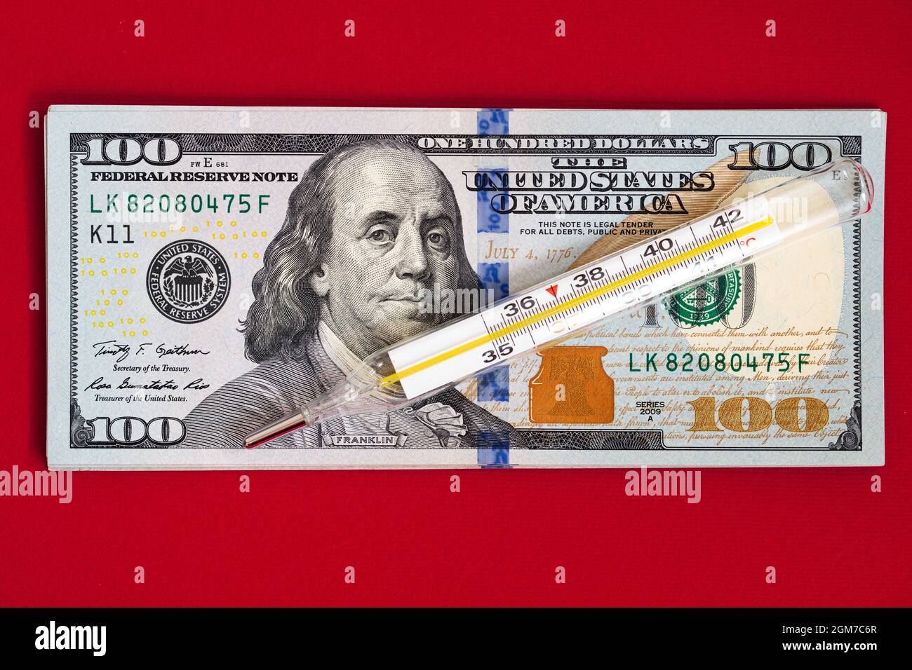 100 dollar bill and thermometer Stock Photo - Alamy