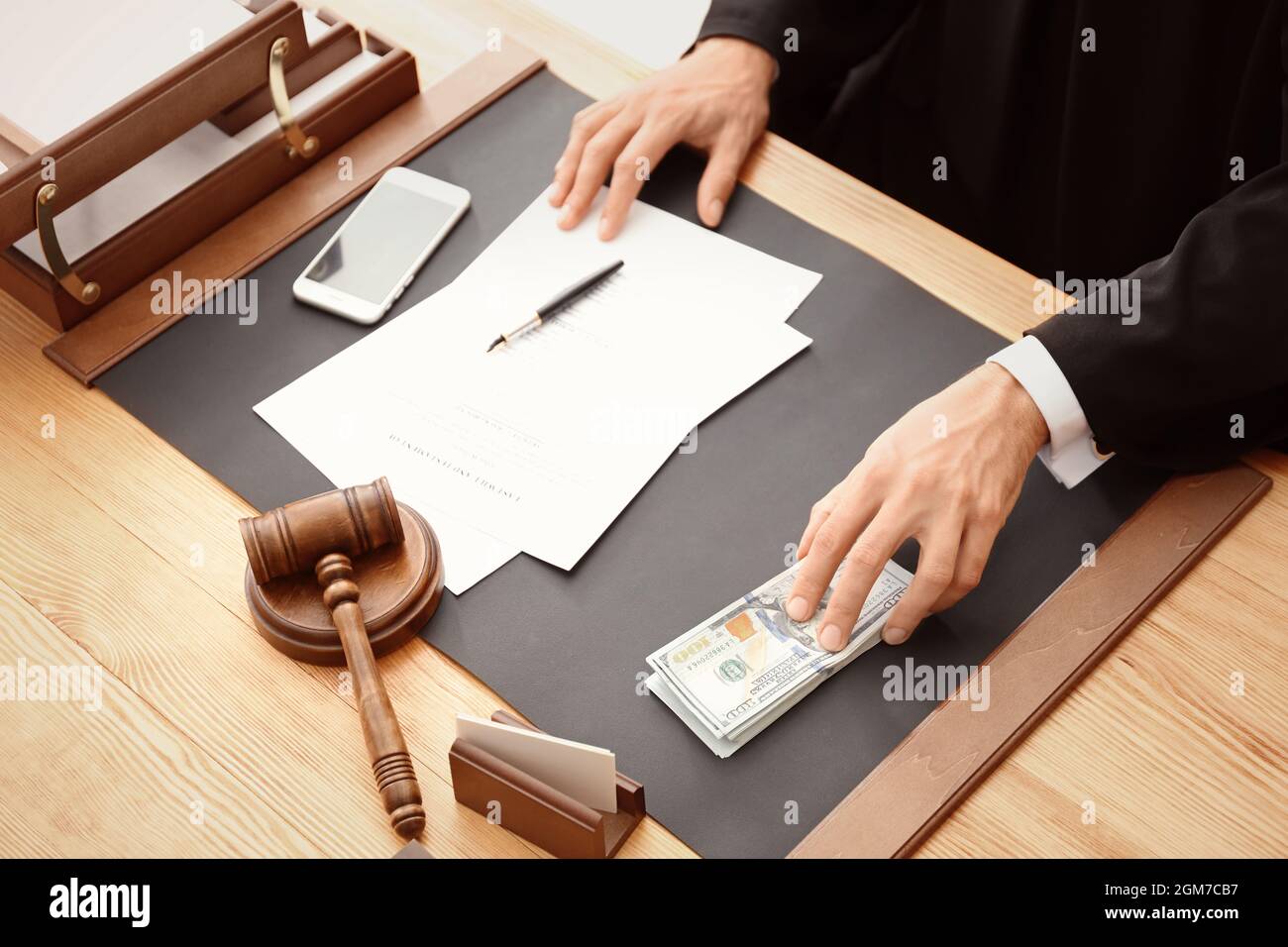 Male judge with bribe at table, closeup Stock Photo - Alamy