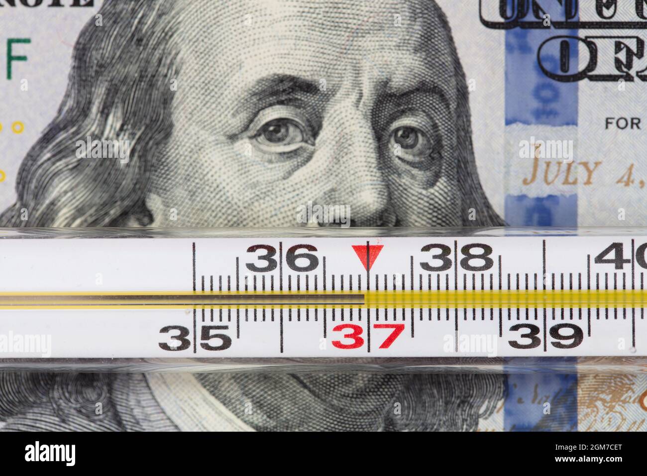 100 dollar bill and thermometer Stock Photo - Alamy