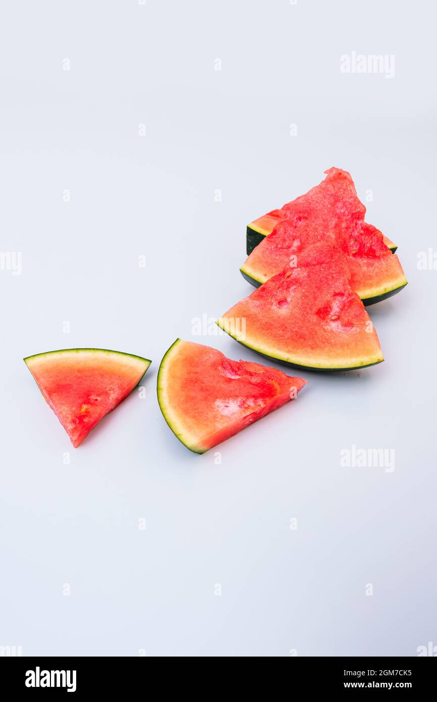 Triangular seedless watermelon chunks on light colored table Stock ...