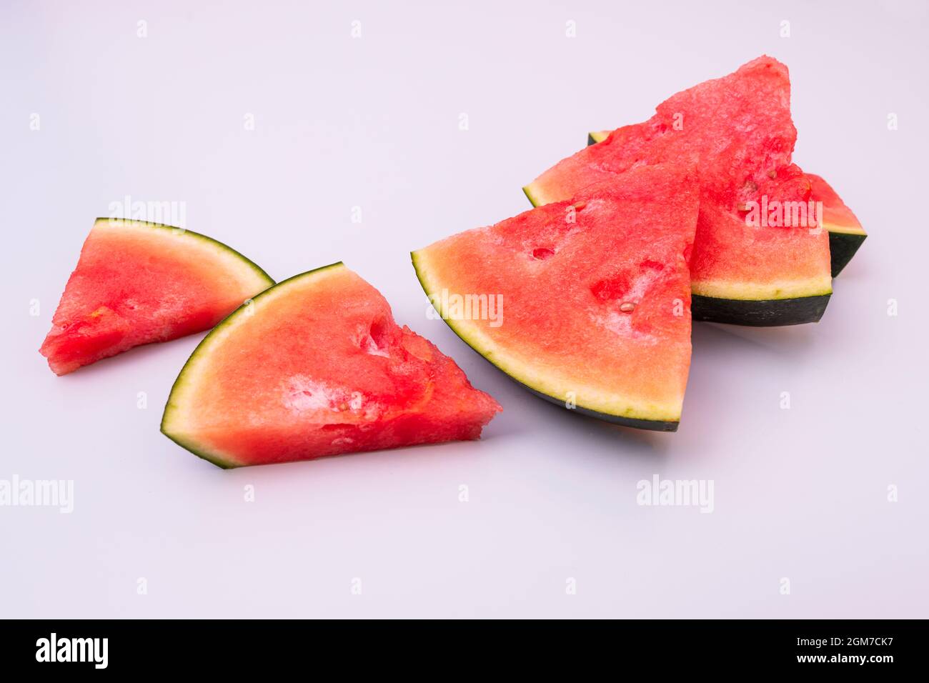 watermelon slices with red pulp without seeds on a blue plain ...