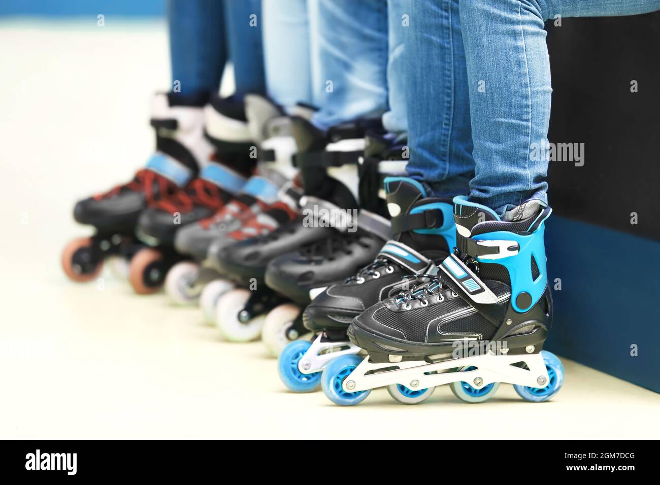 Group of people wearing roller skates on light background Stock Photo ...
