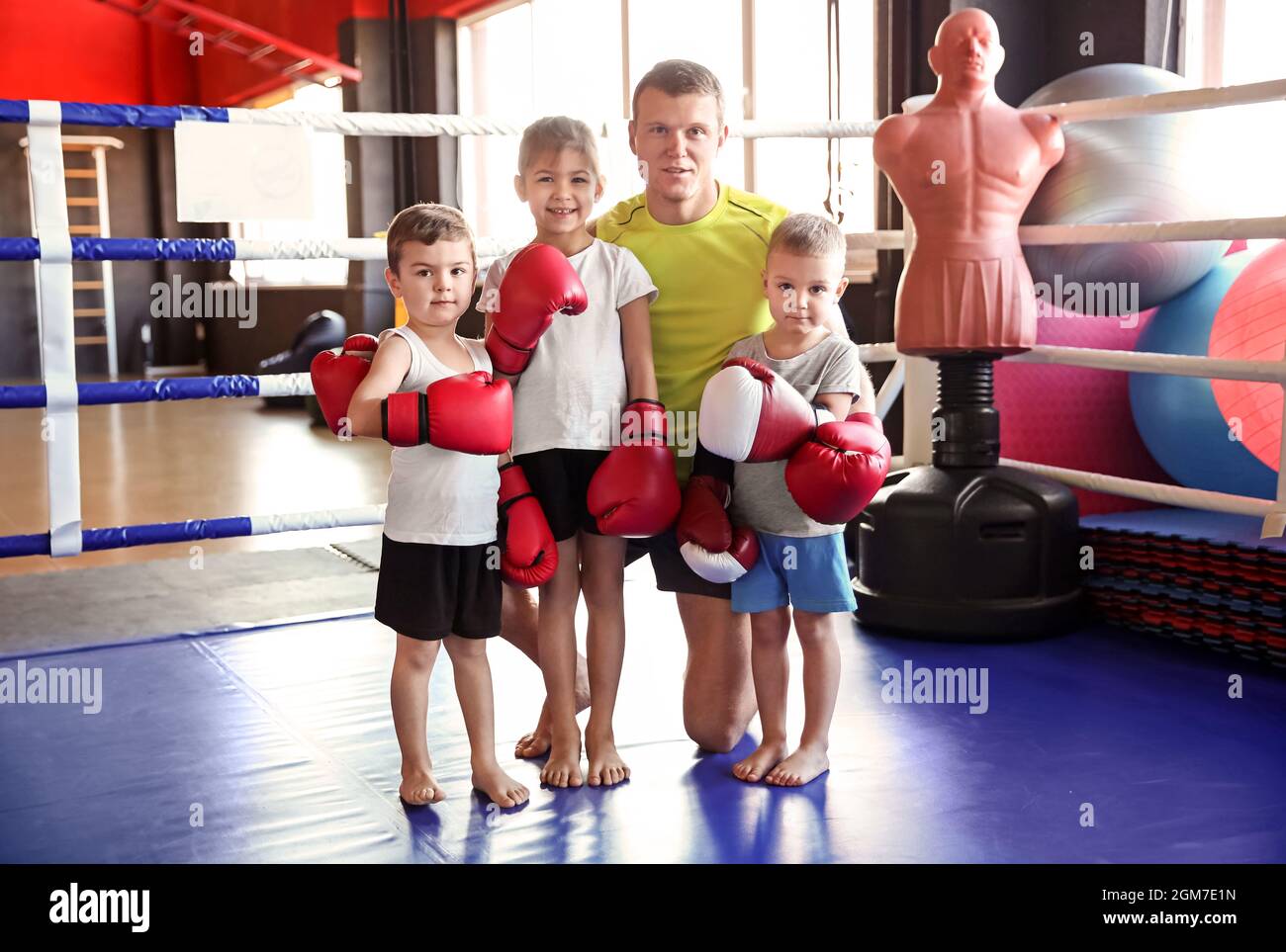 Little children with trainer in boxing ring Stock Photo - Alamy