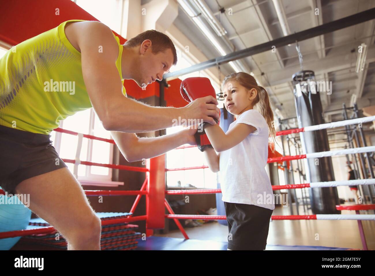 Little girl training with coach in boxing ring Stock Photo - Alamy