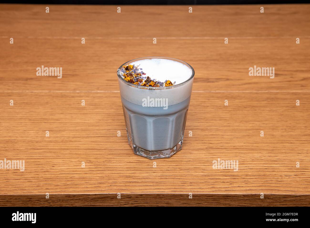 Blue detox drink with cream and dried flowers Stock Photo - Alamy