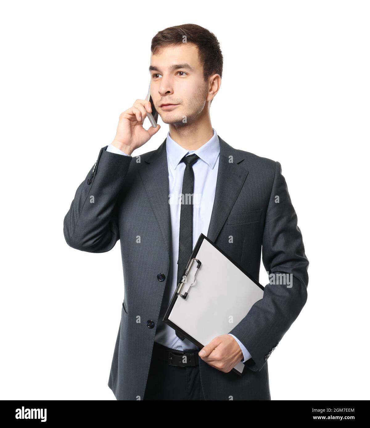 Handsome car salesman talking on mobile phone against white background ...