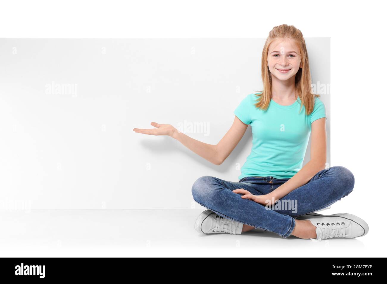 Cute girl with blank advertising board on white background Stock Photo ...