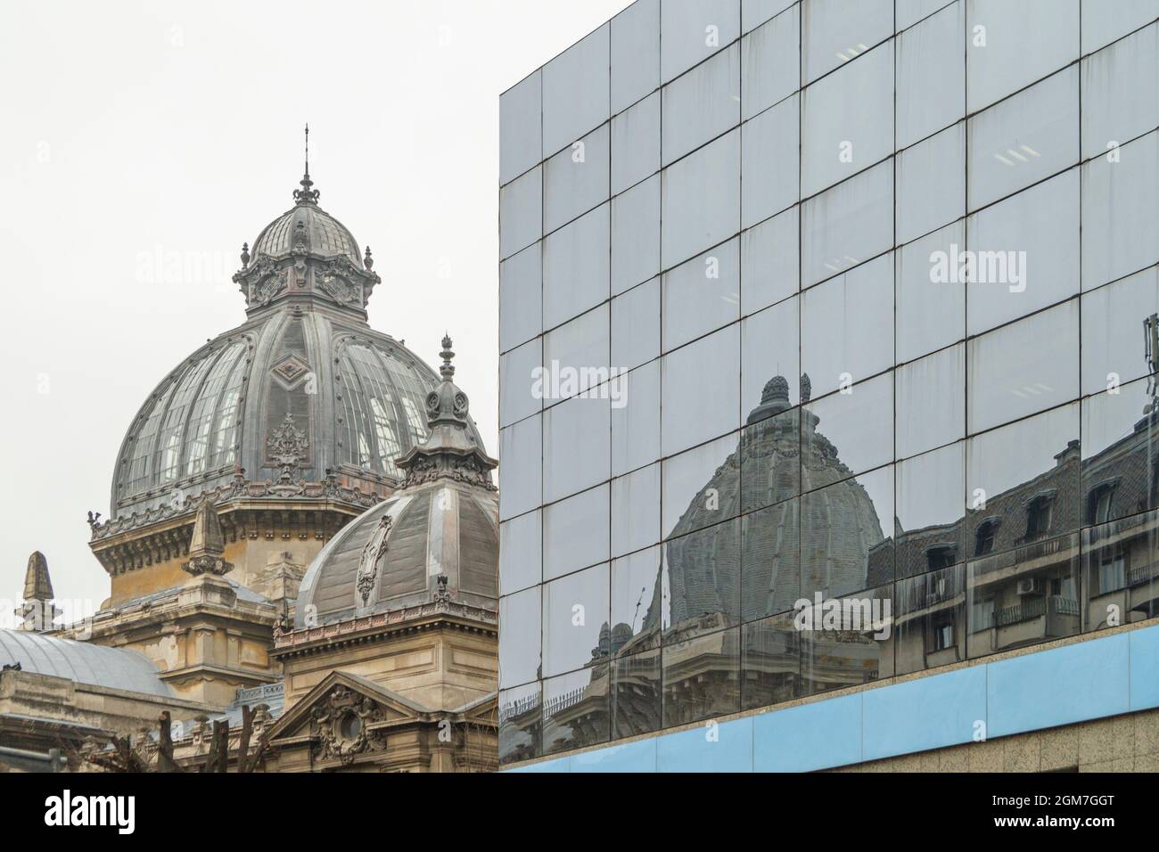 Glass dome of a bank in the center of Bucharest and reflection in the glass of a neighboring ...
