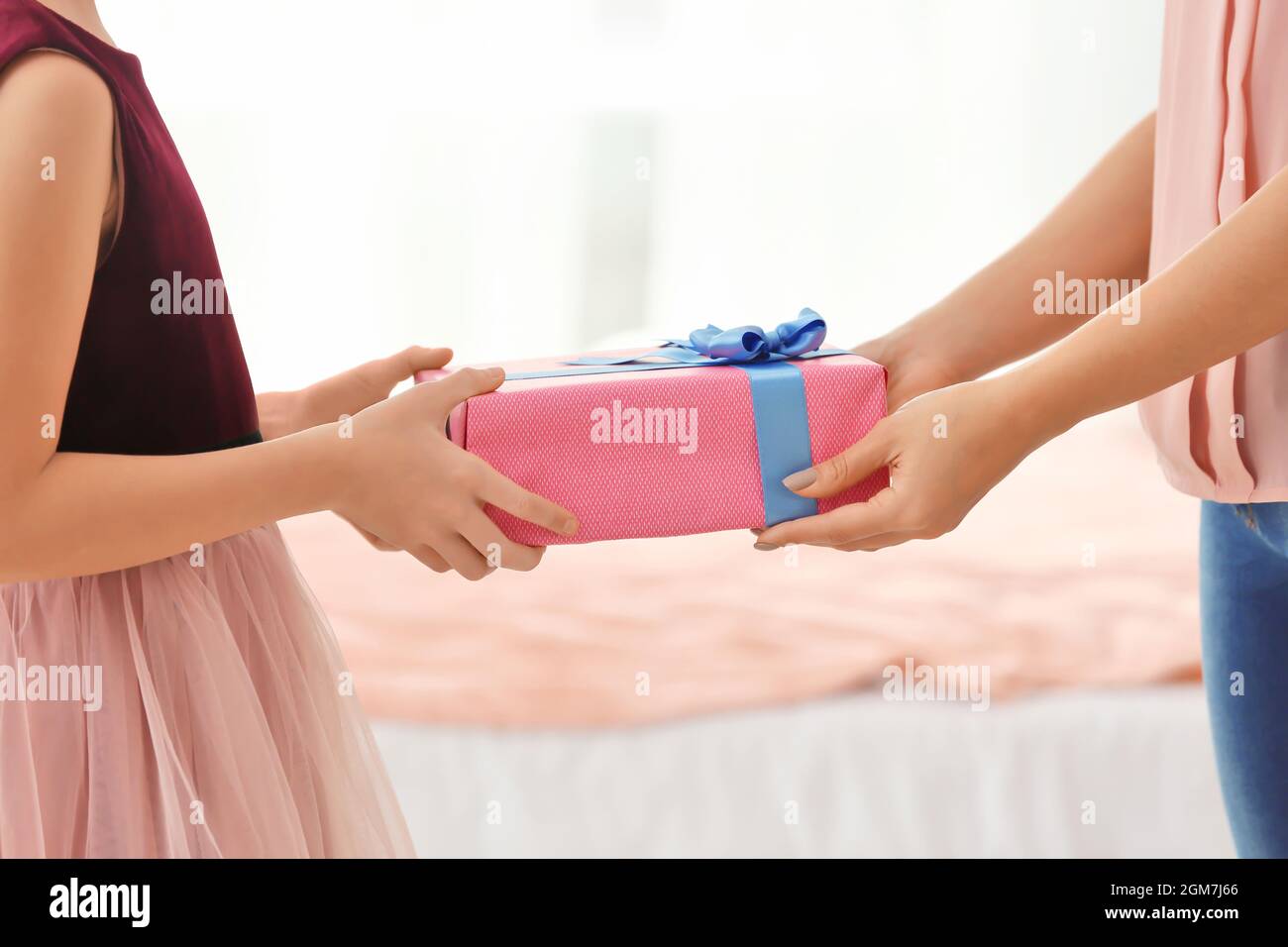Little girl giving gift box to her mom indoors. Mother's day celebration Stock Photo - Alamy