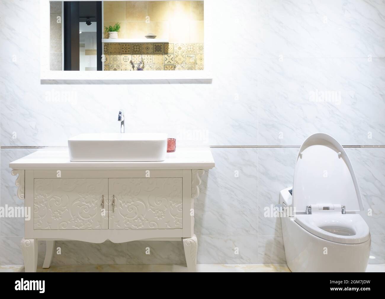 Modern spacious bathroom with bright tiles with toilet and sink. Side ...