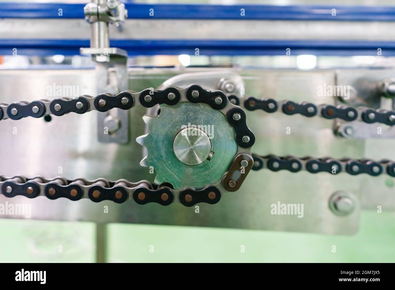 Gear and chain drive shaft in conveyor chain, and conveyor belt is on ...