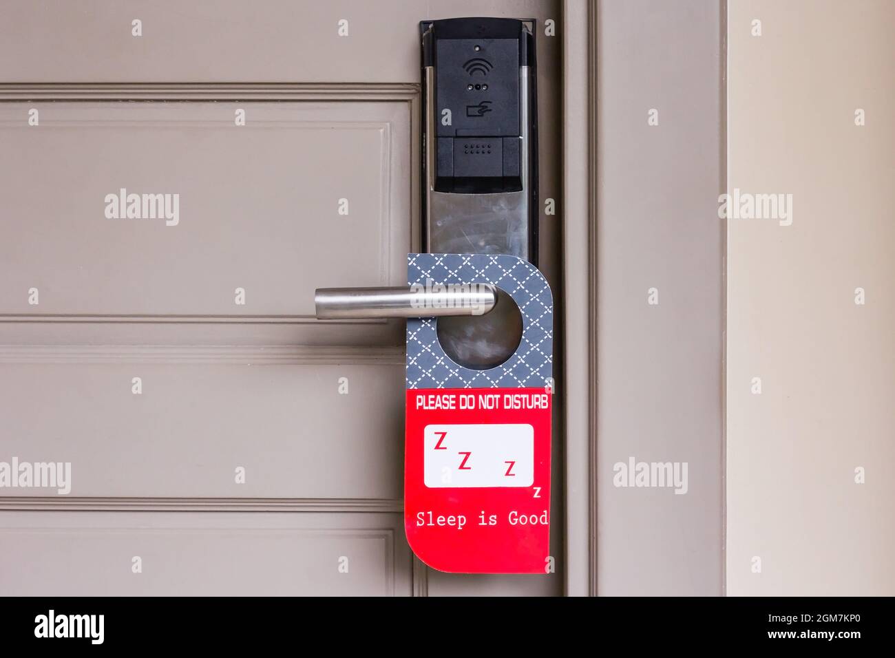 Closed door of hotel room with please do not disturb sign hang on door ...