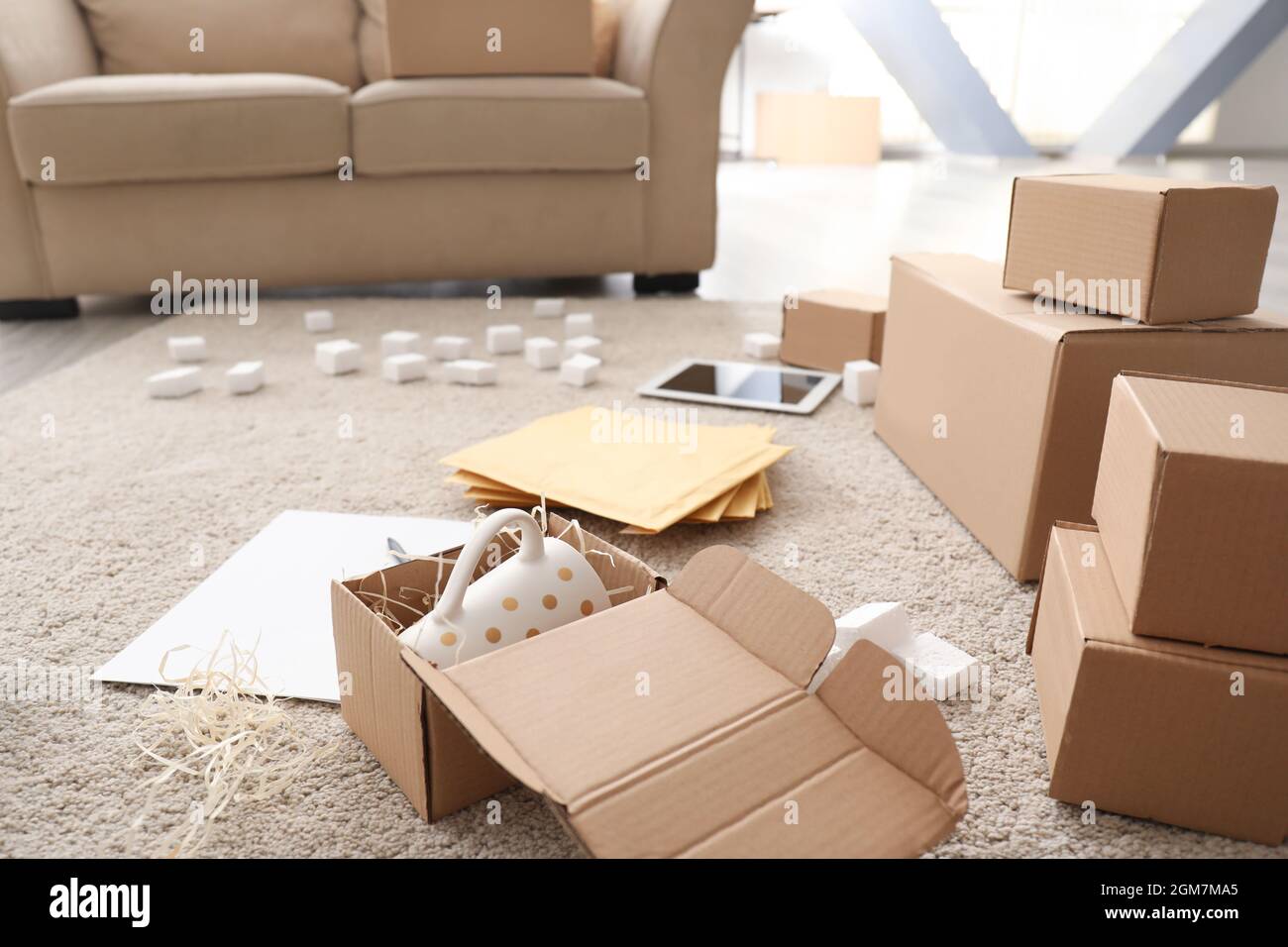 Open parcel with cup and carton boxes on floor at home Stock Photo - Alamy