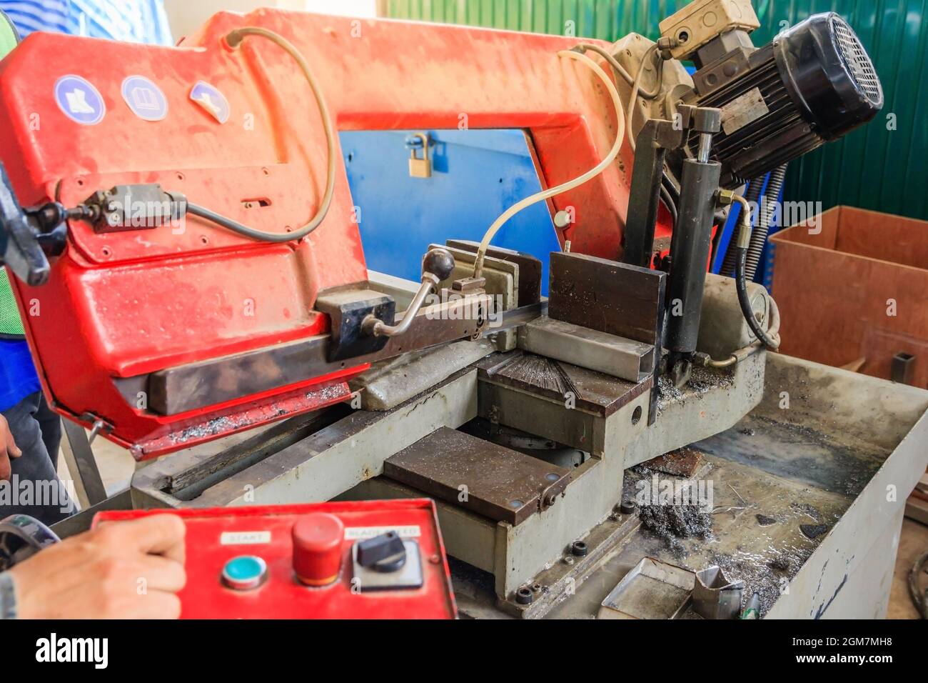 Industrial worker working with cutting steel Machine red color in ...