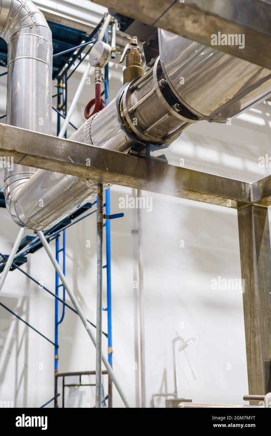 Leakage of steam in heat pipeline. Steam outgoing from the rusty tube ...