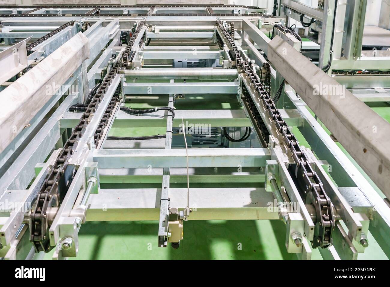 Detail of chain of roller conveyor on production line.- Shallow DOF ...