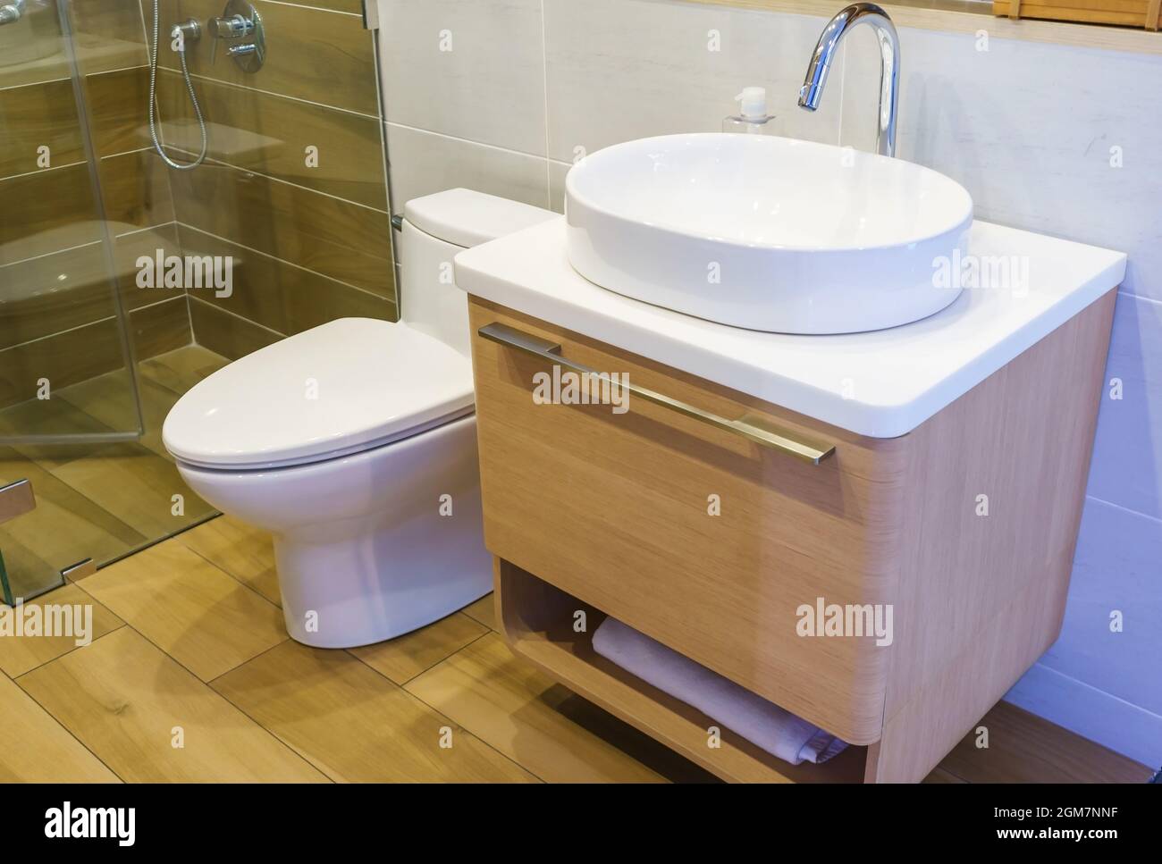 Modern spacious bathroom with bright tiles with toilet and sink. Side ...