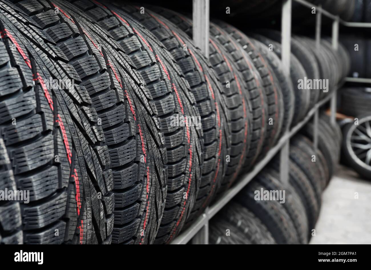 Rack with variety of car tires in automobile store Stock Photo - Alamy