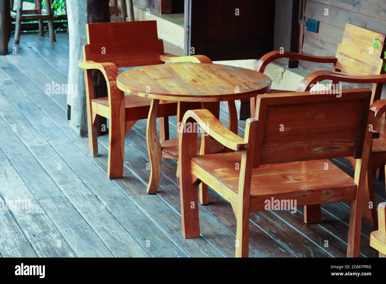 Wood furniture in wooden house. Table has round shape with set of wood ...