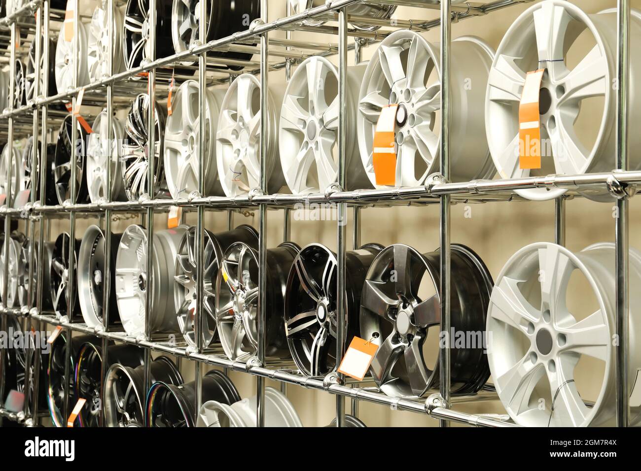 Rack with car wheels in automobile store Stock Photo - Alamy