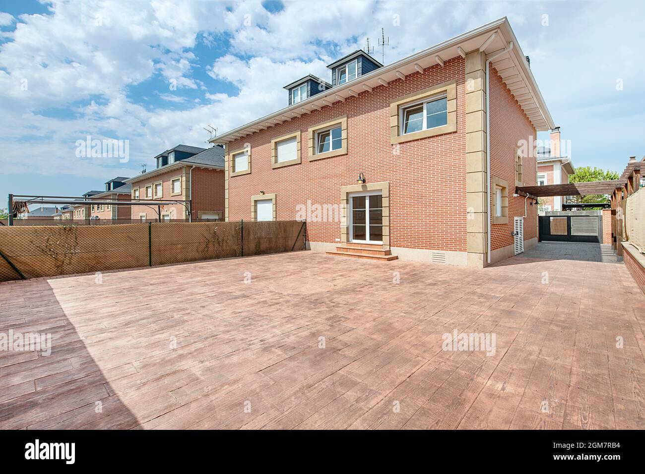 large patio tiled in wood ceramic simile of a single-family house on ...