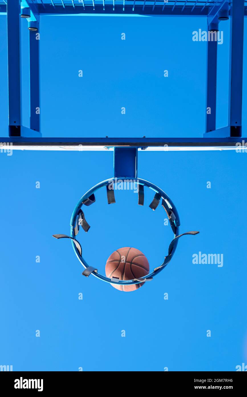 Street basketball ball falling into the hoop Stock Photo - Alamy