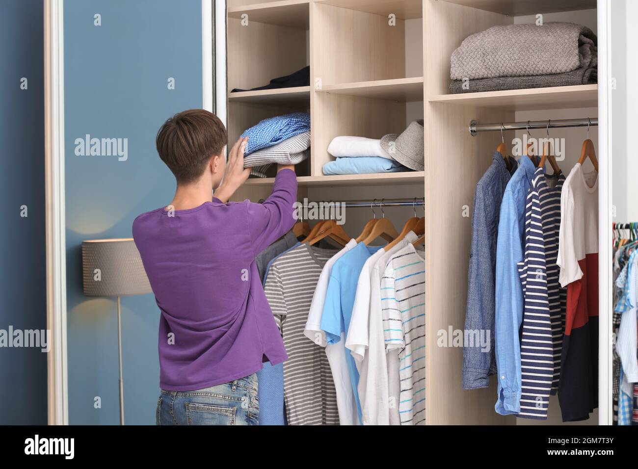 Teen boy choosing clothes hi-res stock photography and images - Alamy