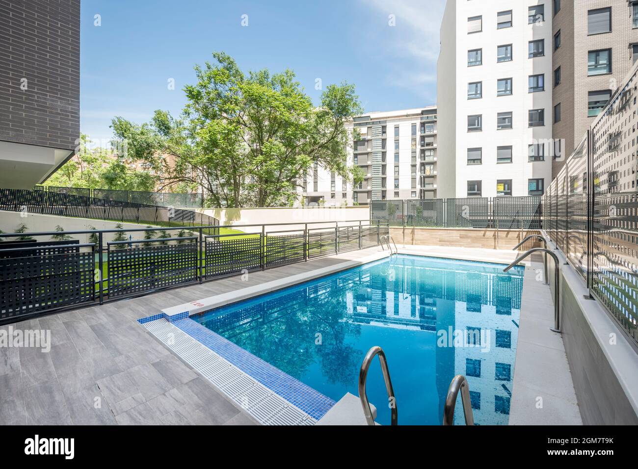 Common areas in apartment buildings with communal pool Stock Photo - Alamy