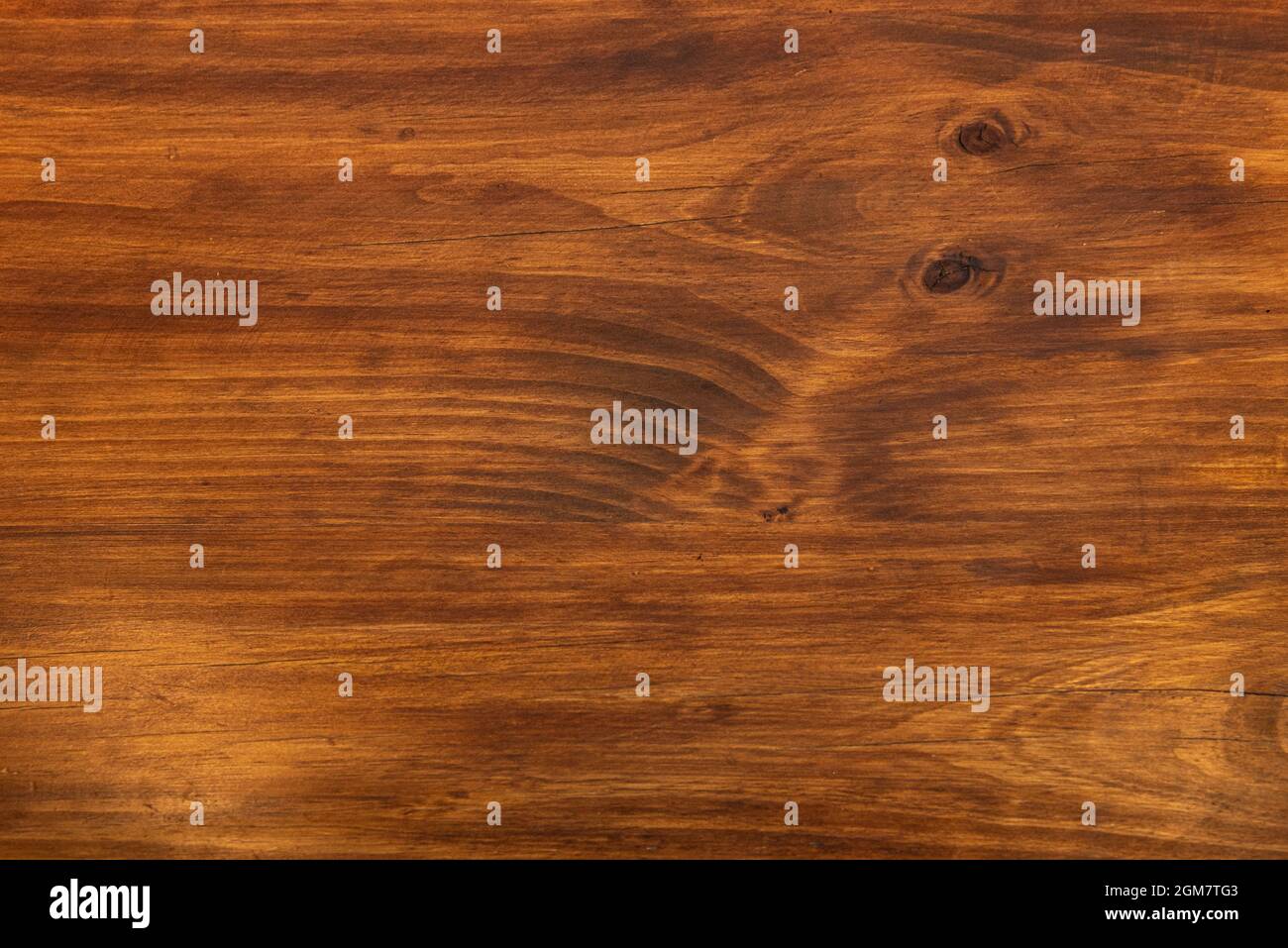 Wooden table top viewed from above with pronounced knots and grain ...